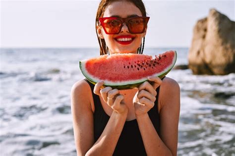 Premium Photo Portrait Of Young Woman Holding Seashell At Beach