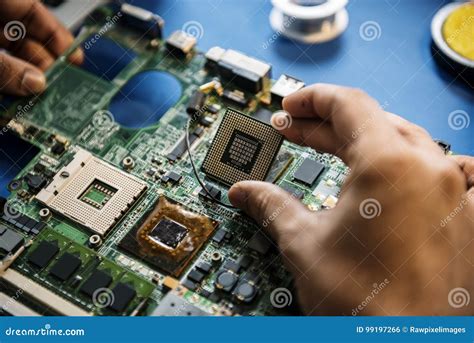 closeup of hands with computer mainboard microprocessor electronics