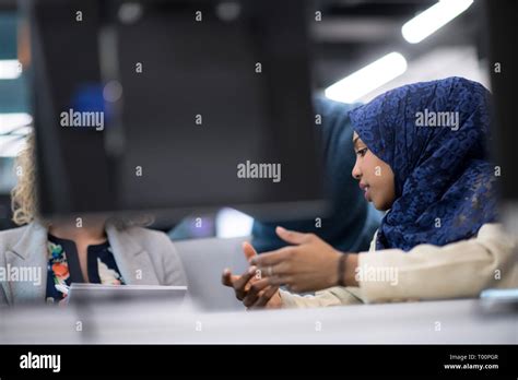 Black Muslim Female Software Developer Working Together With Her Multiethnics Business Team