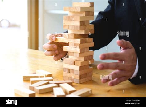 businessmen picking dominoe blocks to fill the missing dominos and