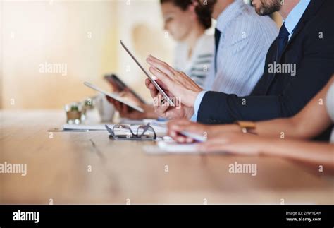 Taking Digital Notes Shot Of Businesspeople Using Their Digital