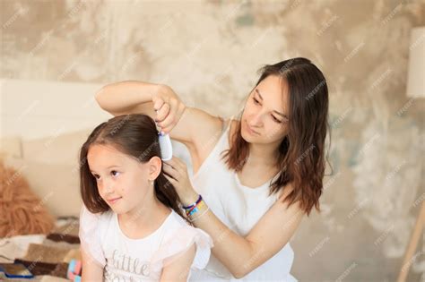 Premium Photo A Girl Getting Her Hair Done In A Room