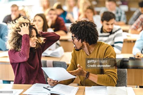 Frustrated College Couple Arguing On A Class At School High Res Stock