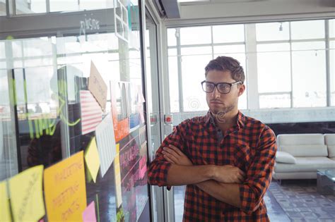 Thoughtful Businessman Looking At Adhesive Notes In Office Stock Image