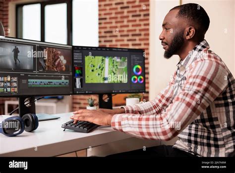 Graphic Artist Editing Film Footage On Software Using Visual Effects And Color Grading To Edit