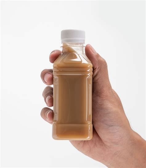 Premium Photo Hand Holding Plastic Bottle Product