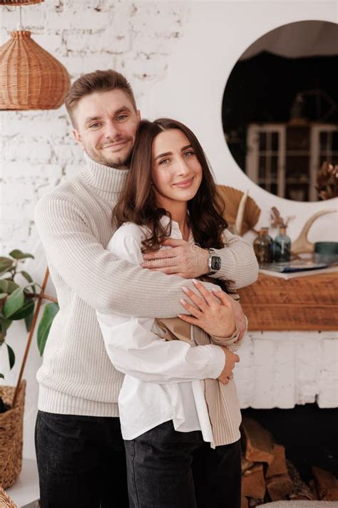 Happy Young Couple In Love Is Hugging Gentle And Smiling Together