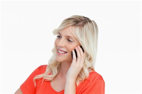 Premium Photo Smiling Woman Talking On A Mobile Phone While Looking