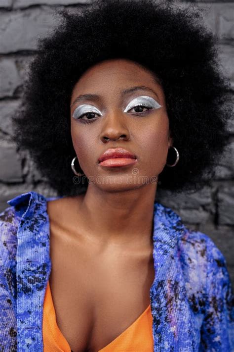 Dark Haired Beautiful Model With Bright Makeup Looking Serious Stock