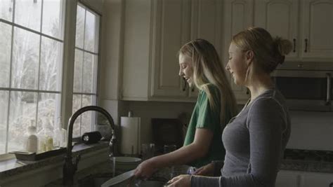 Smiling Sisters Washing Dishes And Singing To Music In Kitchen Highland Utah United States