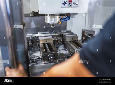 Rear View Close Up Of An Unrecognizable Man Working With Milling Machine In Cnc Factory Stock