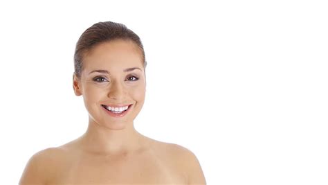 Smiling Brunette Woman Wearing Pink Glasses Against A White Background