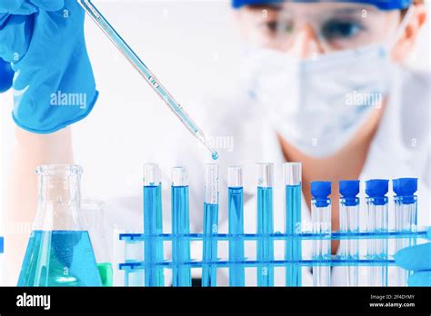 Development Of New Vaccines Hand Of Scientist Holding Flask With Lab Glasware And Test Tubes In