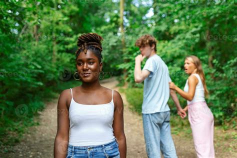 Disloyal Man Walking With His Girlfriend And Looking Amazed At Another