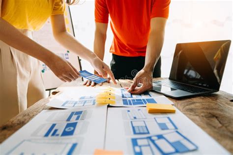 Ux Developer And Ui Designer Brainstorming About Mobile App Interface Wireframe Design With