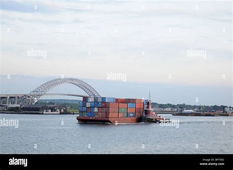A Tug Pushes A Barge Laden With Containers Across The Kill Van Kull In