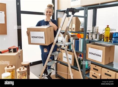 Young Caucasian Woman Volunteer Holding Donations Box Laughing And