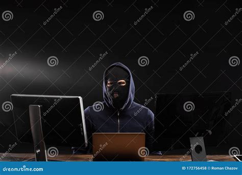 Serious Hacker Male In The Hood Sit With Laptop Stock Photo Image Of