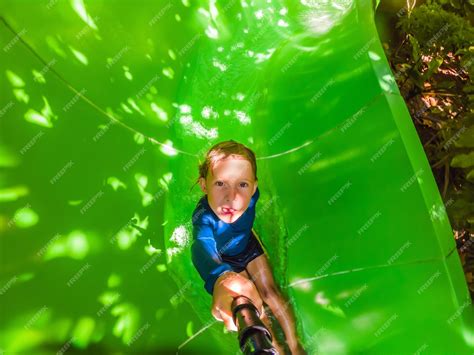 Premium Photo Happy Boy On Water Slide In A Swimming Pool Having Fun