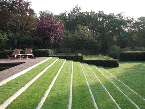 From The Brick Terrace Grass Steps Lead Down To A Expansive Lawn