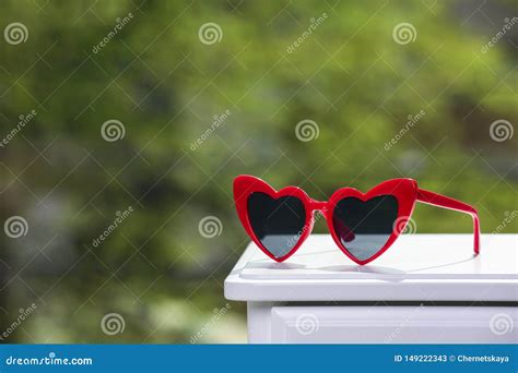 Stylish Heart Shaped Sunglasses On Table Against Blurred Background Stock Image Image Of