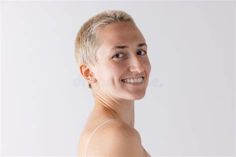 Portrait Of Young Short Haired Blonde Girl Posing Looking At Camera