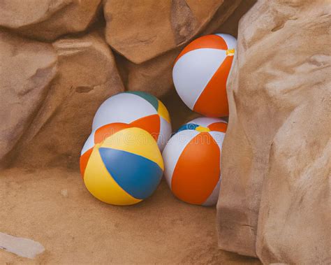 Beach Balls Stuck Between Big Rocks At The Beach Stock Image Image Of