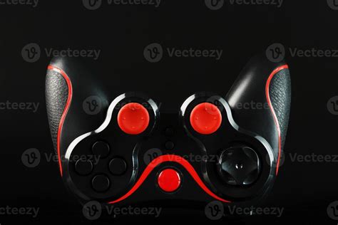 Black Game Controller Gamepad With Red Buttons On Black Background Upside Down Close Up 14538911