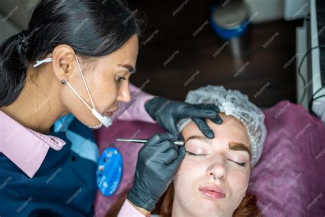 Premium Photo Procedure Of Eyebrow Microblading A Master In Black