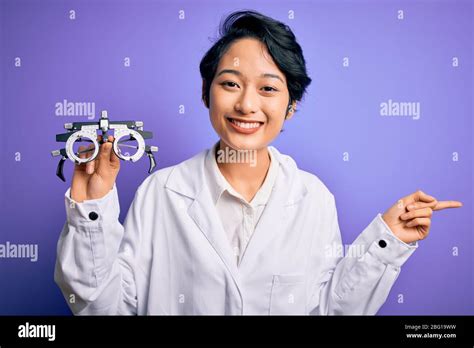 Beautiful Asian Optical Girl Wearing Coat Holding Optometry Glasses