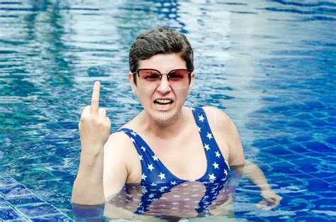 Angry Woman In Pool Showing Middle Finger Up Inappropriate Behavior In