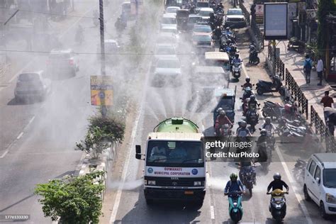 A Gmch Truck Sprinkles Water On The Road To Curb Pollution In News