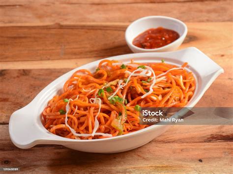Sezwan Veg 국수국은 국수 채소 슈슈완 소스로 만든 인기 있는 인도중국 요리로 소박한 나무 배경 선택적인 초점 위에