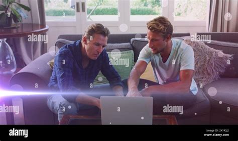 Image Of Light Spots And Trails Over Caucasian Man And His Adult Son