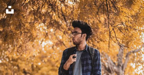 Man In Black And Gray Plaid Dress Shirt And Black Pants Standing Near