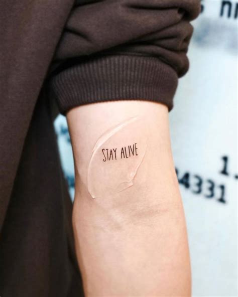 Stay Alive Lettering Tattoo Located On The Bicep
