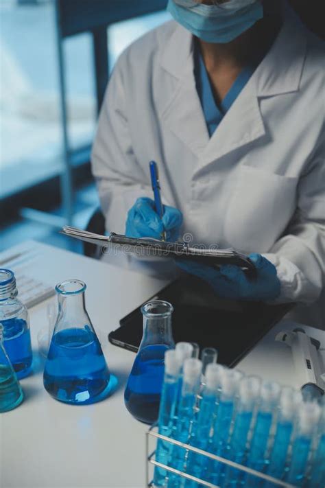 Professional Chemist Woman Laboratory Using Scientific Microscope For