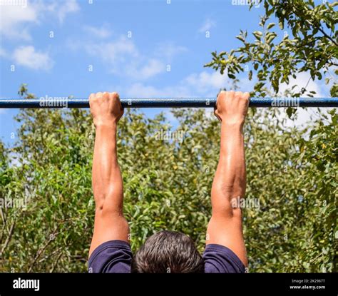 Hands On The Bar Close Up The Man Pulls Himself Up On The Bar Playing Sports In The Fresh Air