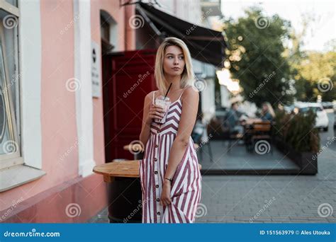 Fashionable Young Positive Woman In A Stylish Pink Striped Sundress