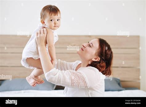 Mother Lifting Baby Stock Photo Alamy