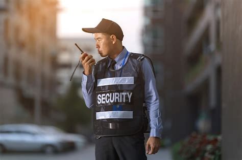 Premium Photo | Security man standing outdoors using portable radio