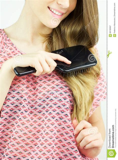 Closeup Of Beautiful Girl Brushing Long Wavy Silky Blonde Hair Stock