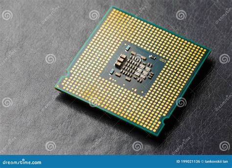 The Microprocessor Processor Of The CPU Of A Computer Or Laptop Lies On A Dark Matte Surface
