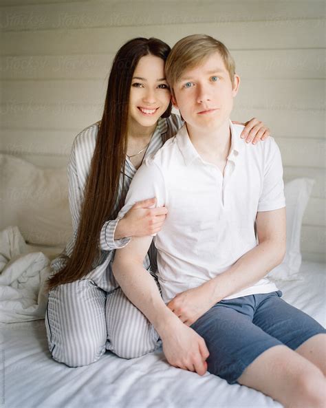 Hugging Pair Looking At Camera By Stocksy Contributor Duet