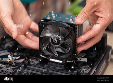 Engineer Man Installing Aluminum Heat Sink Install At Computer Circuit Board For Cooling Chips