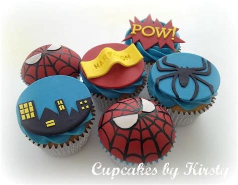 Spiderman Cupcakes Are Decorated With Blue Frosting And Red Icing