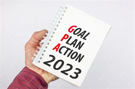 Premium Photo Businessman Holding Notepad With Words Goal Action Plan