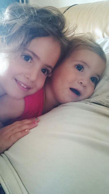 Premium Photo Siblings Relaxing On Bed At Home