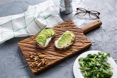 Sliced Avocado On Toast Bread With Nuts Breakfast And Healthy Food