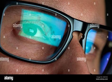 Trader Looking At Computer Screen Analyzing Trading Chart Reflecting In